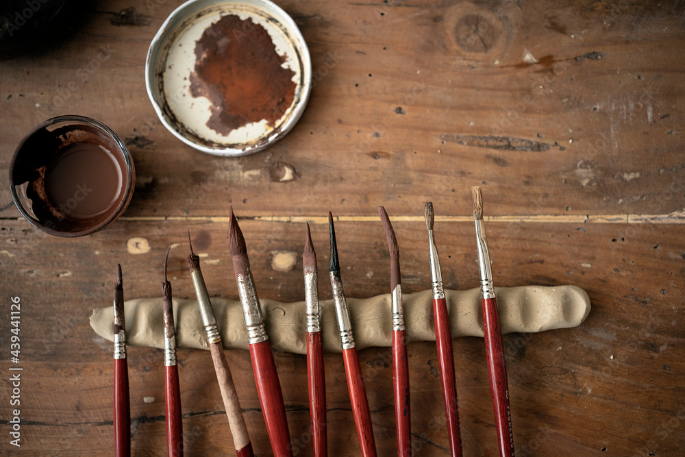 Brushes of different sizes in a wooden table Stock Photo | Adobe Stock
