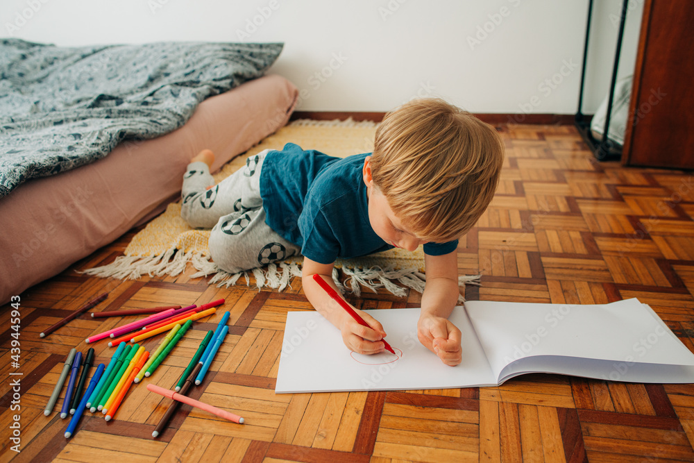 Preschooler making drawings with markers Stock Photo | Adobe Stock