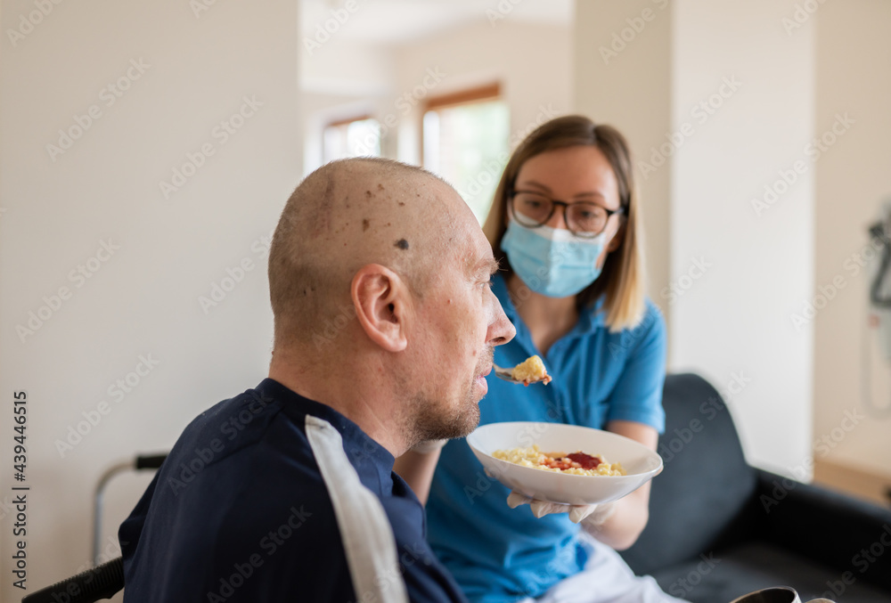 Nurse Feeding Patient Stock Photo | Adobe Stock