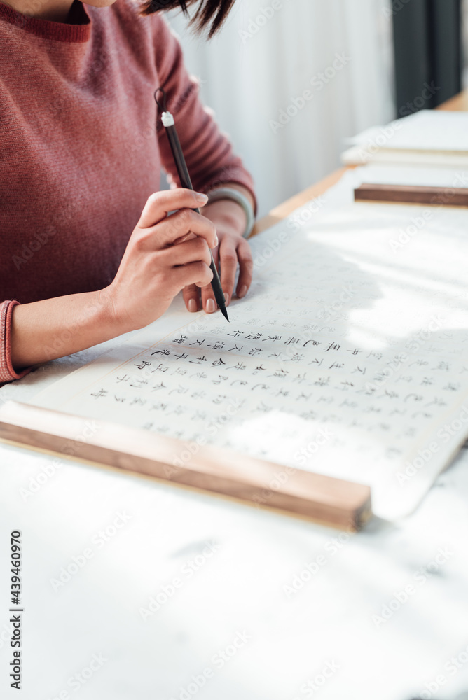 Asian woman writing calligraphy Stock Photo | Adobe Stock