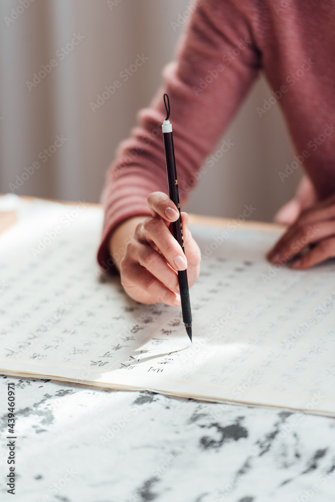 Asian woman writing calligraphy Stock Photo | Adobe Stock