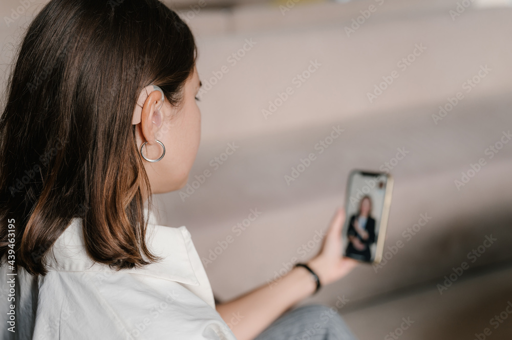 Deaf female entrepreneur making video call Stock Photo | Adobe Stock