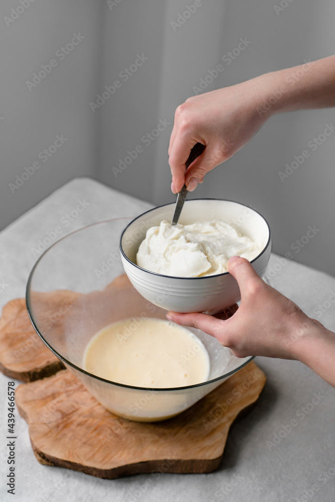 Lemon pie cooking. Pouring yogurt into the dough Stock Photo | Adobe Stock