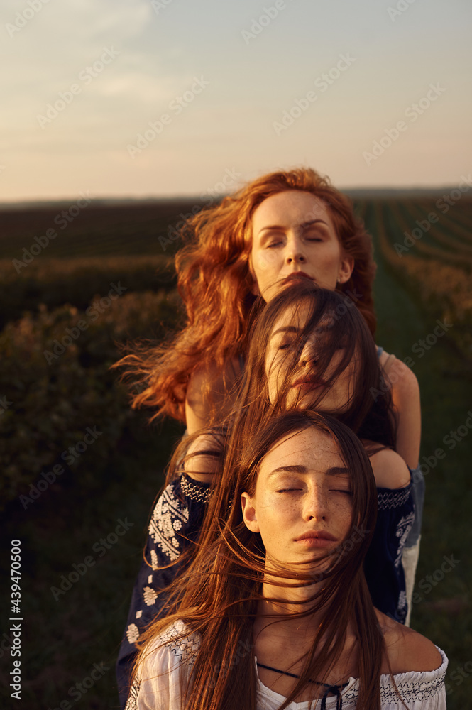 Close up in a row of faces of three different women with different ...