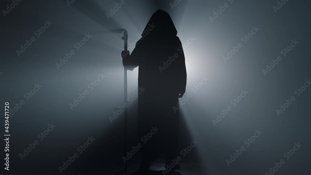 Silhouette grim reaper standing indoors. Death with scythe spotlight ...