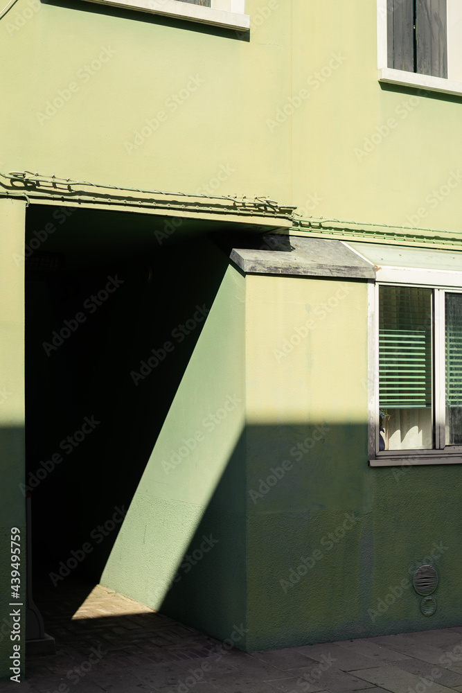 Shadow in entrance of building on street. Minimal facades of Burano ...