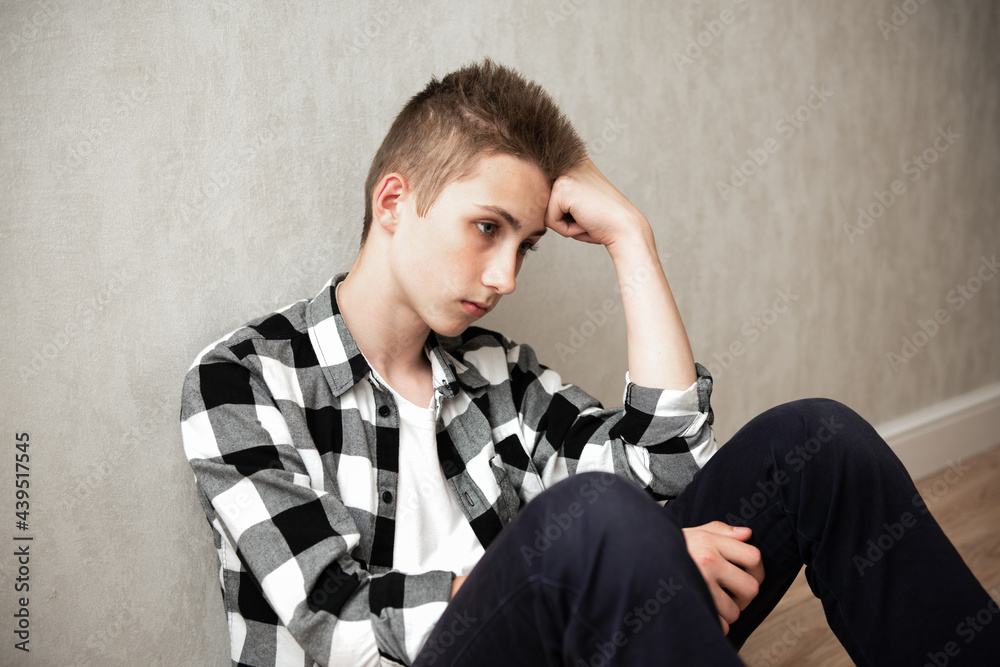 Shame, regret and despair. Sad lonely teen boy with depression or ...