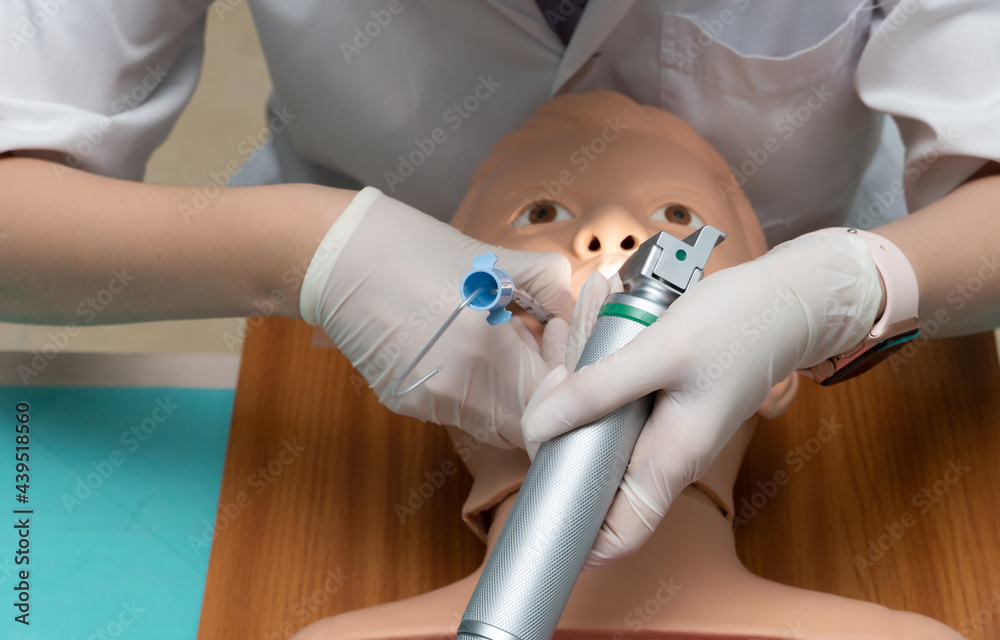 Anesthesiologist performing an orotracheal intubation on a simulation ...