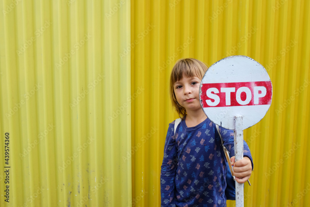 Portrait of a child boy holding a STOP sign Stock Photo | Adobe Stock