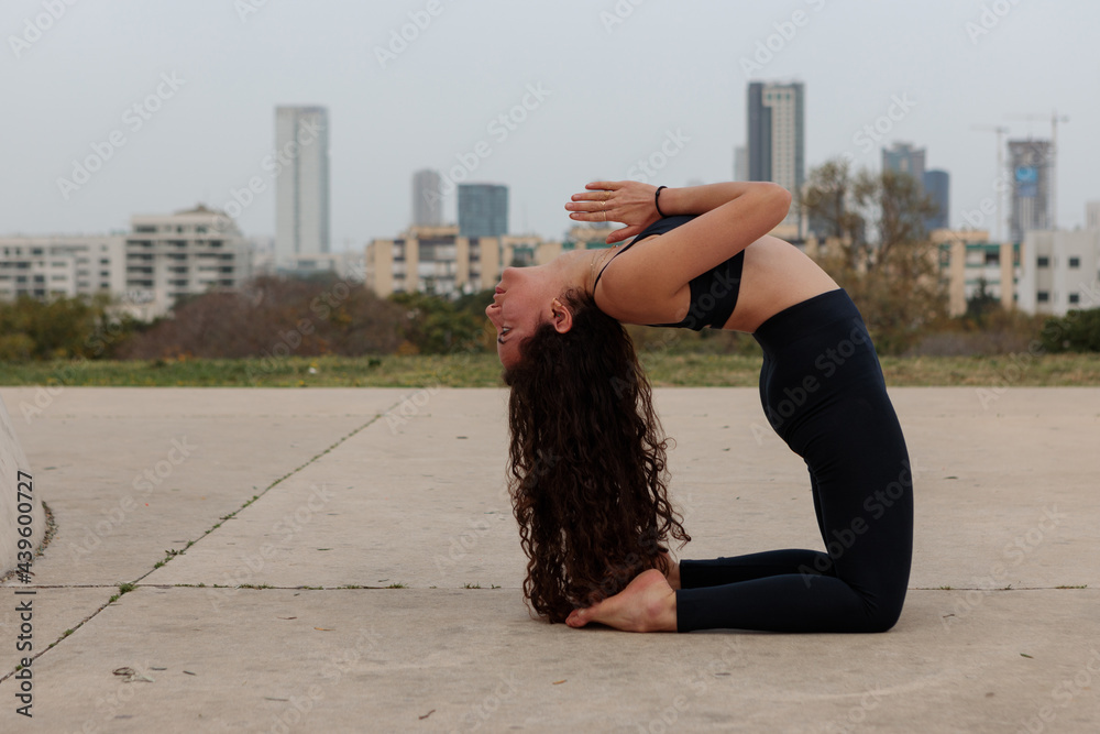 Pretty And Flexible Young Woman Bending Her Back In A Yoga Pose Shot
