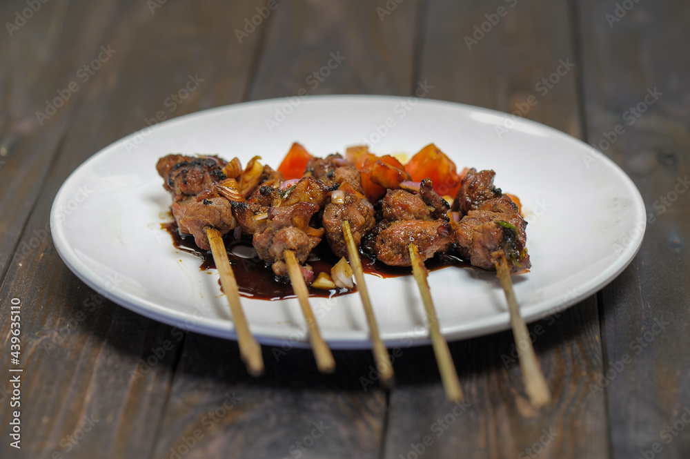 Indonesian sate sticks made of chicken and pork on mini presentation ...