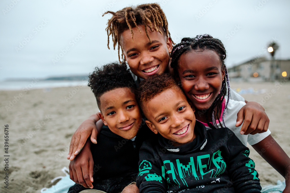 Happy Black siblings on beach blanket Stock Photo | Adobe Stock