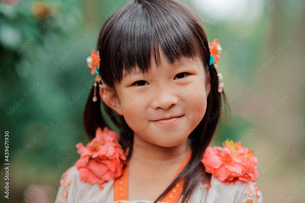 Chinese little girl wearing traditional clothes Stock Photo | Adobe Stock