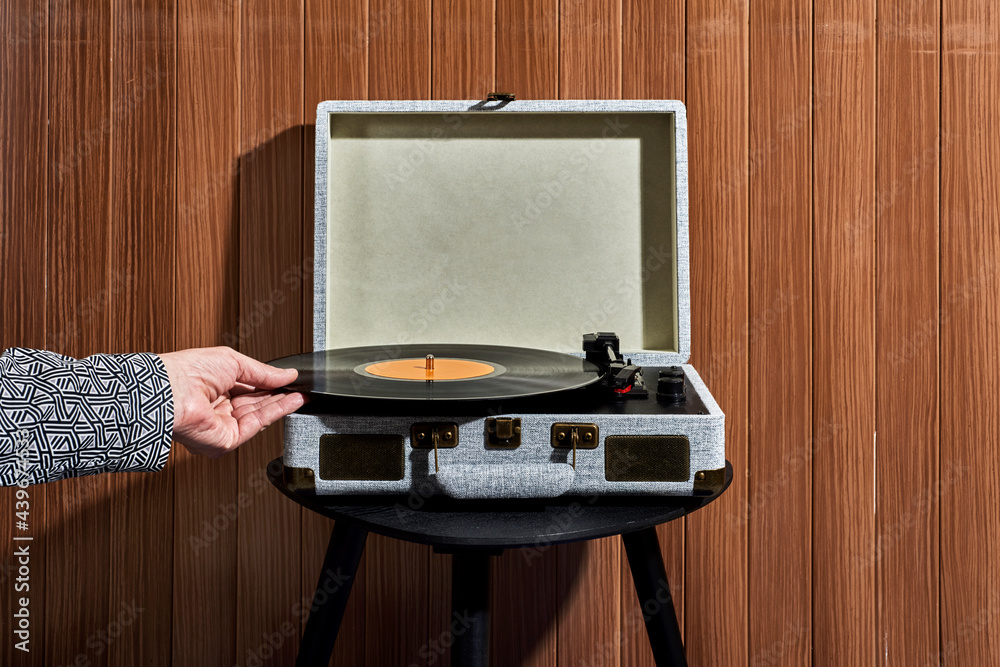 man about to play a disc in a turntable Stock Photo | Adobe Stock