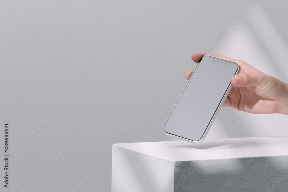 Hand holding a mobile phone Stock Photo | Adobe Stock