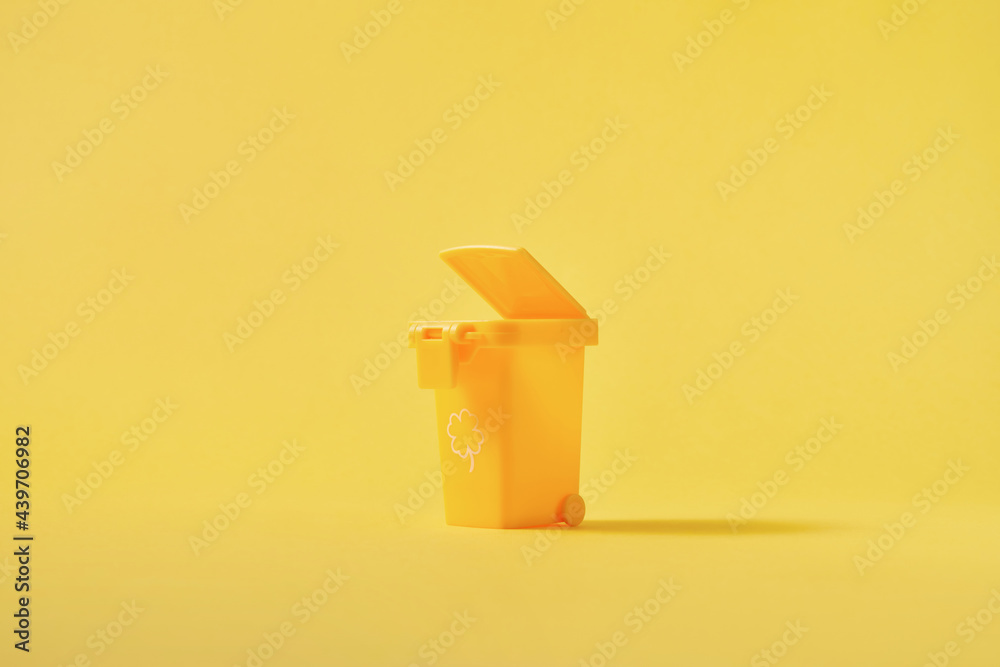 Small open yellow trash can for recycling Stock Photo | Adobe Stock