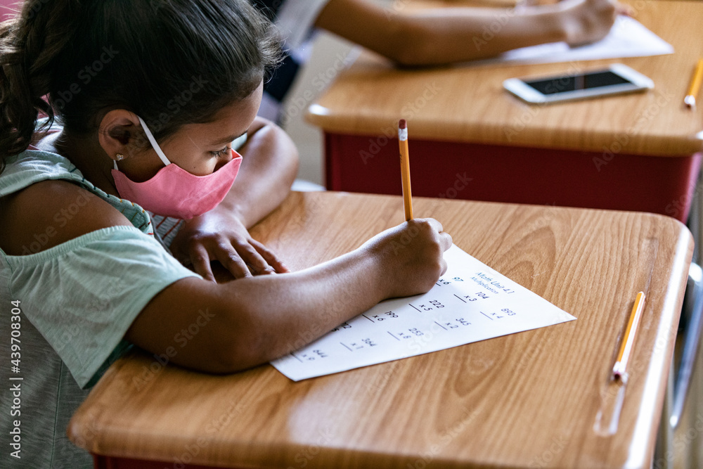 School: Student With Face Mask Works On Math Sheet Stock Photo | Adobe ...