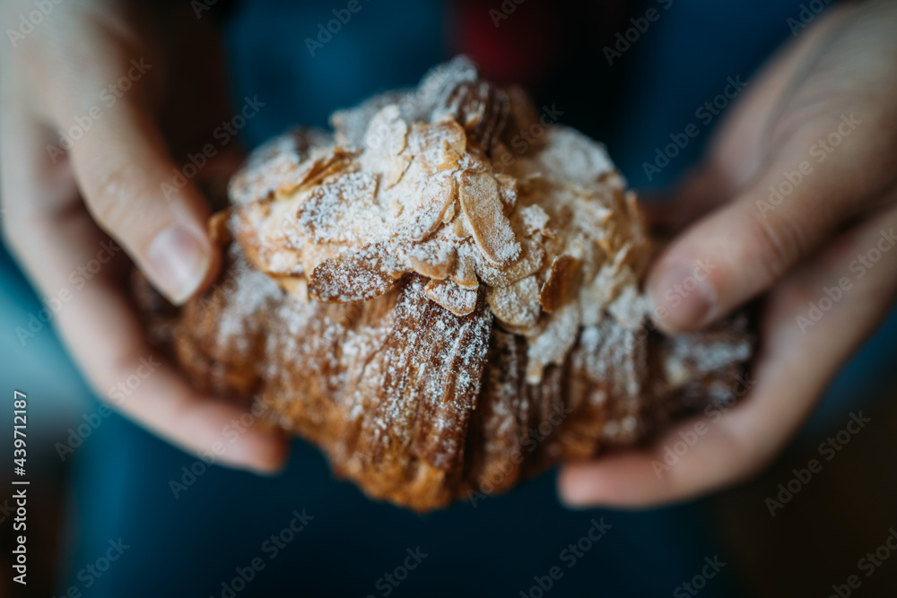 Crop person holding croissant Stock Photo | Adobe Stock