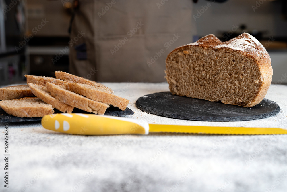 Round bread cut into slices on a kitchen Stock Photo | Adobe Stock