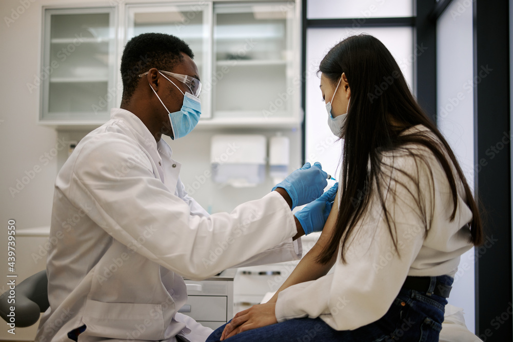 Doctor following safety rules and injecting patient Stock Photo | Adobe ...