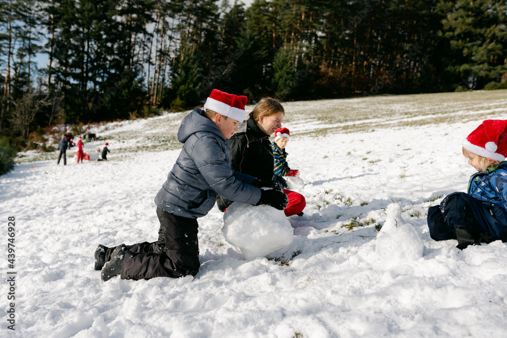little boy making a snowman Stock Photo | Adobe Stock