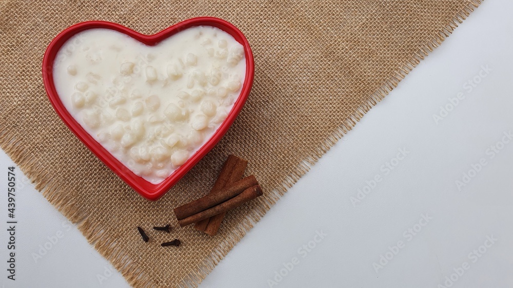 Bowl with sweet hominy dessert, boiled white corn mungunza, cloves ...
