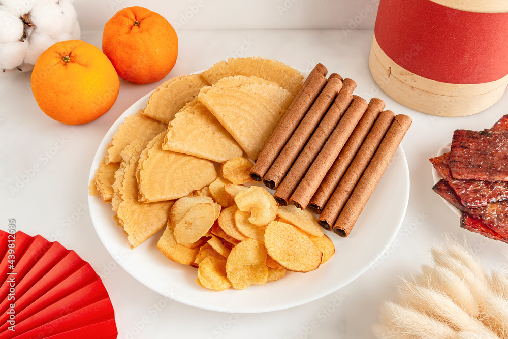 Malaysian Chinese New Year snacks on platter. Kuih kapit, arrowhead ...