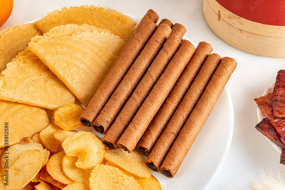 Chocolate wafer rolls in Chinese New Year snack platter alongside kuih ...