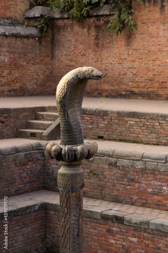 Large bronze snake deity statue seen standing flicking its tongue ...