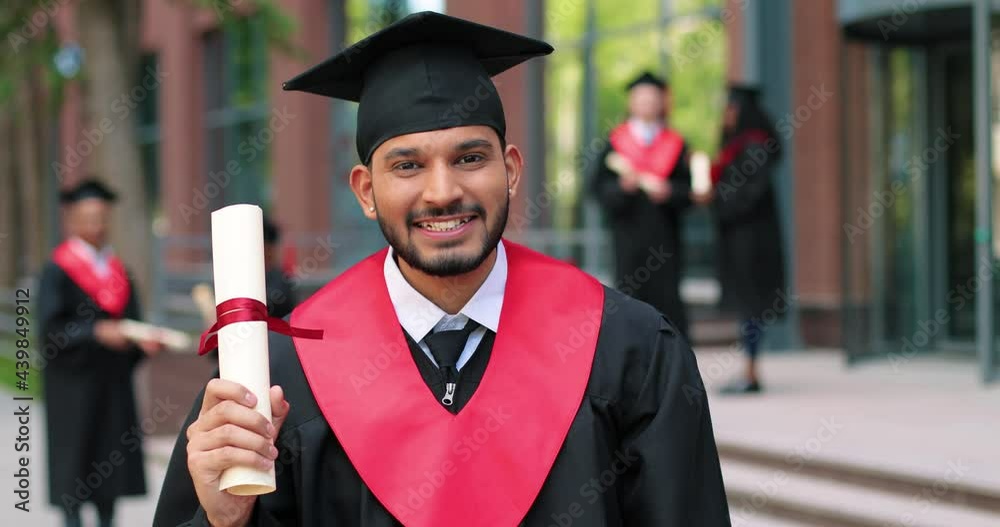 Young graduated boy holding his graduation degree convocation ceremony ...