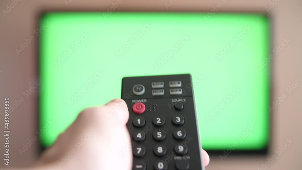 First person view of turning on a TV with a remote control in front of ...