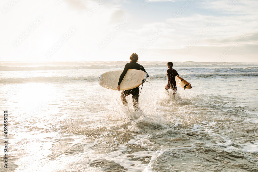 Anonymous surfer friends at the beach with surfboards Stock Photo ...