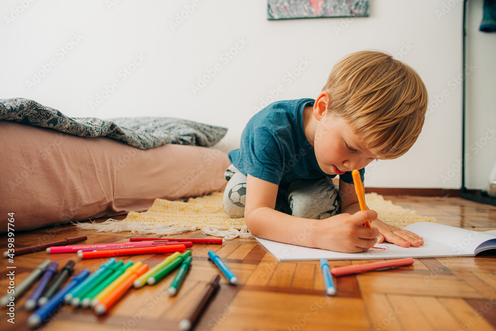 Little boy drawing with colored markers Stock Photo | Adobe Stock