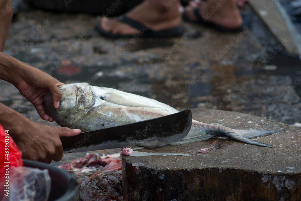 Various types of seafood are sold in the traditional fish market ...
