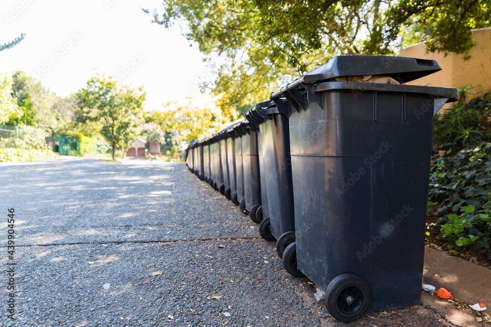 Side View of a Row of Trash Cans Stock Photo | Adobe Stock