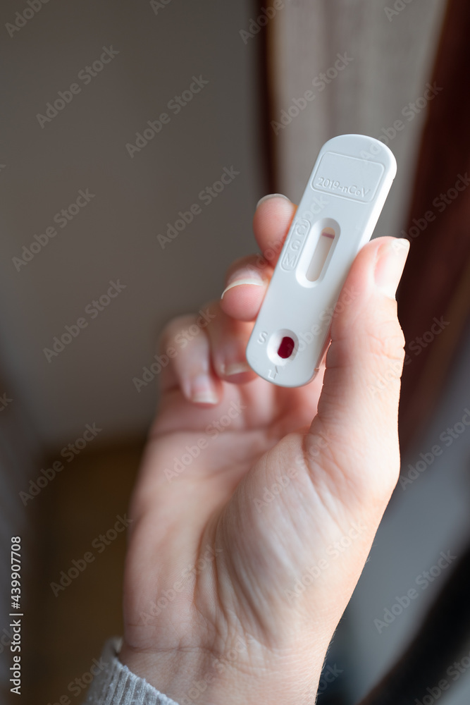 Female hand holding negative COVID-19 Antigen Rapid Test Stock Photo ...
