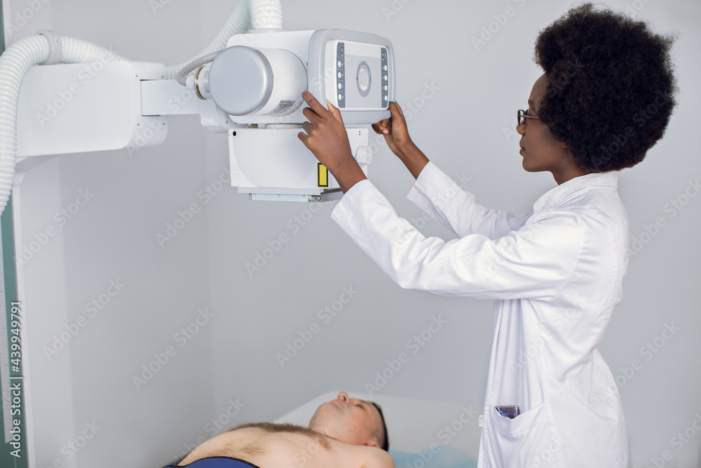 Young african american woman doctor radiologist or technician, setting ...