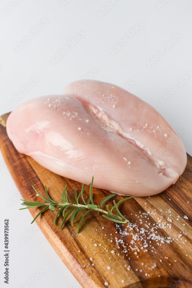 raw chicken breast without skin, over a wood table, white background ...