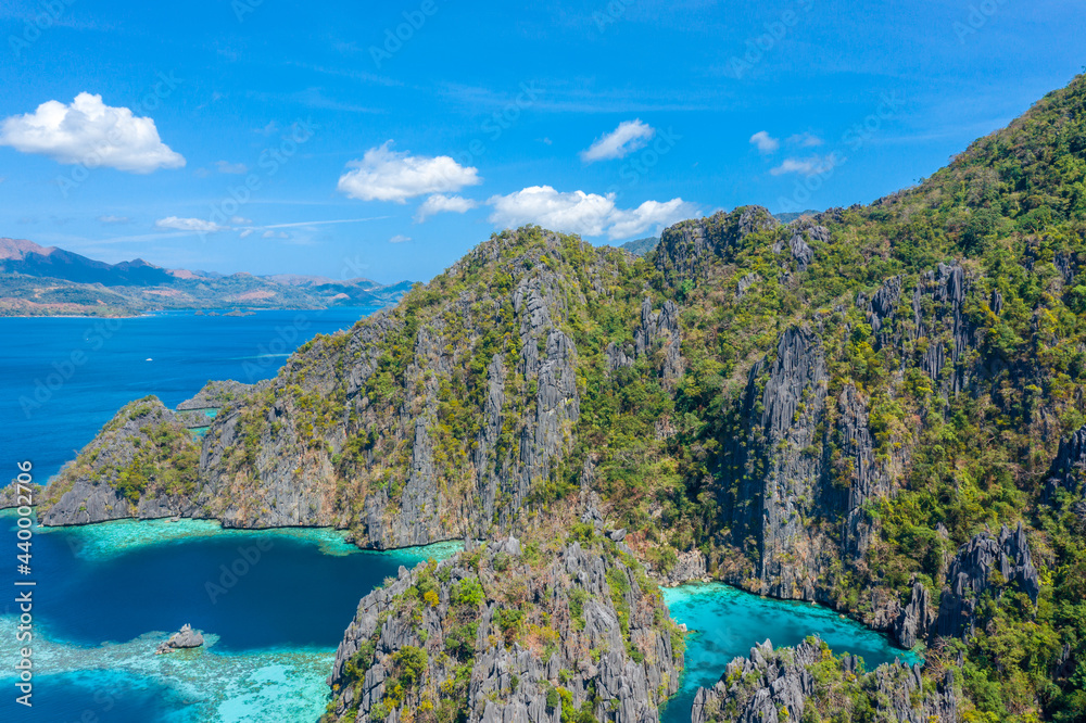Aerial view of turquoise tropical lagoon with limestone cliffs in Coron ...