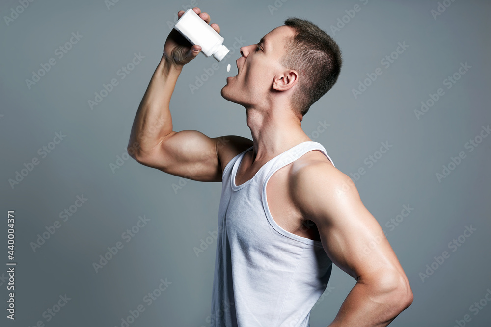 bodybuilder eating pills, steroids. Sport body muscular Man Stock Photo ...