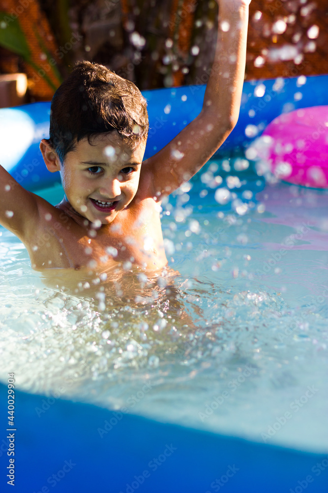 Young boy kid splashing in swimming pool having fun Stock Photo | Adobe ...