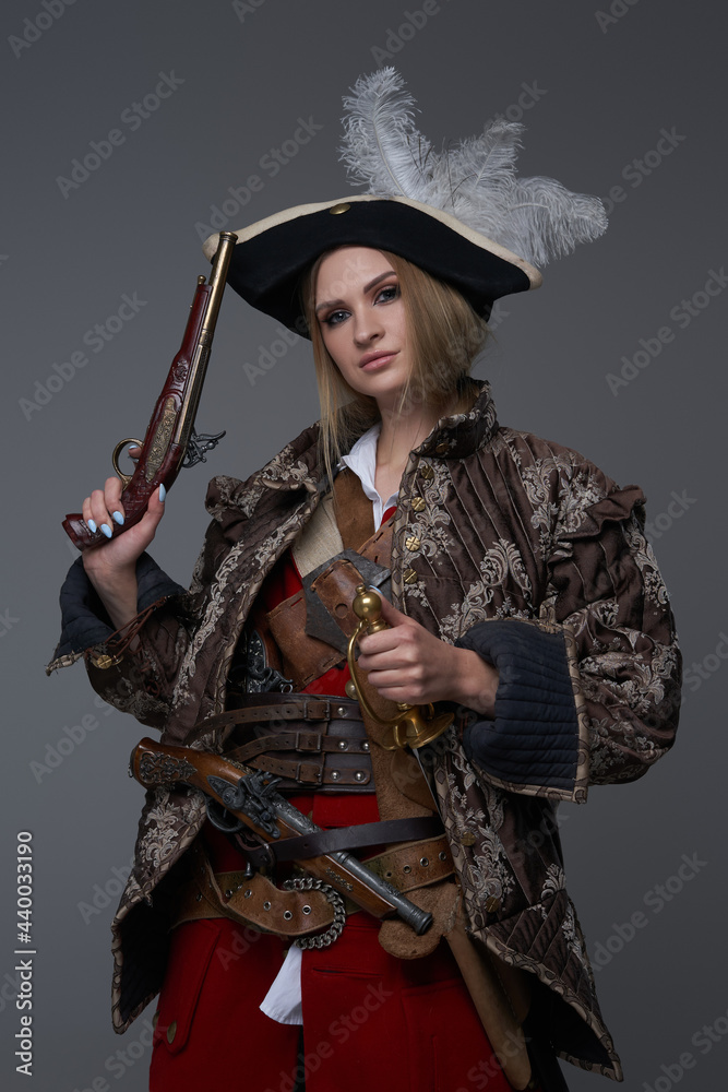 Medieval woman pirate with saber and handgun Stock Photo | Adobe Stock