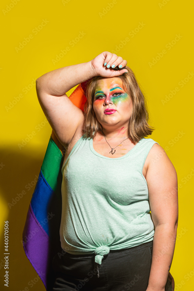 Plus size woman with LGBT flag touching head Stock Photo | Adobe Stock