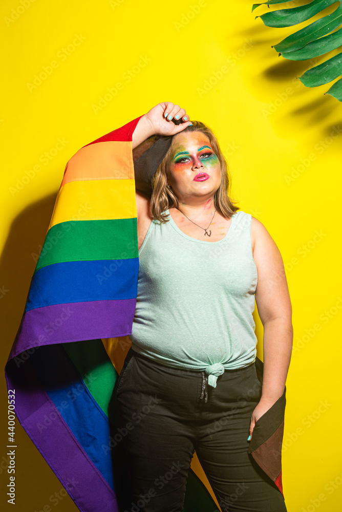 Plus size woman with LGBT flag touching head Stock Photo | Adobe Stock