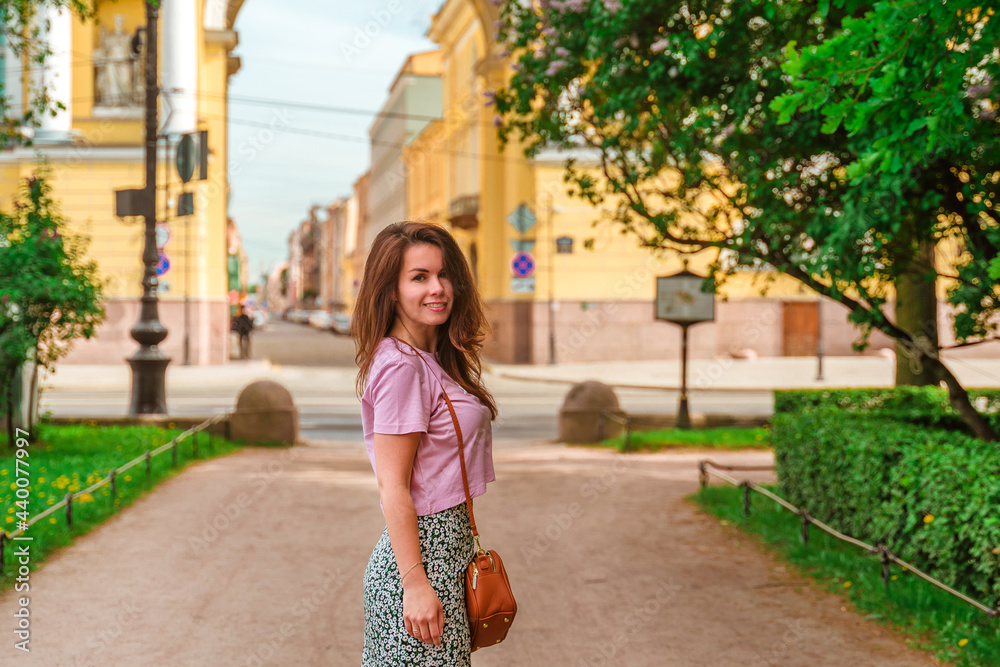 Cute tourist woman in St. Petersburg on the background of a yellow arch ...
