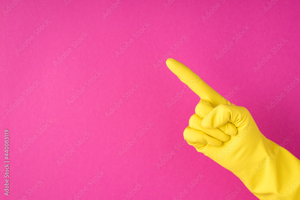 Photo of hand in yellow glove making pointing symbol with forefinger on ...