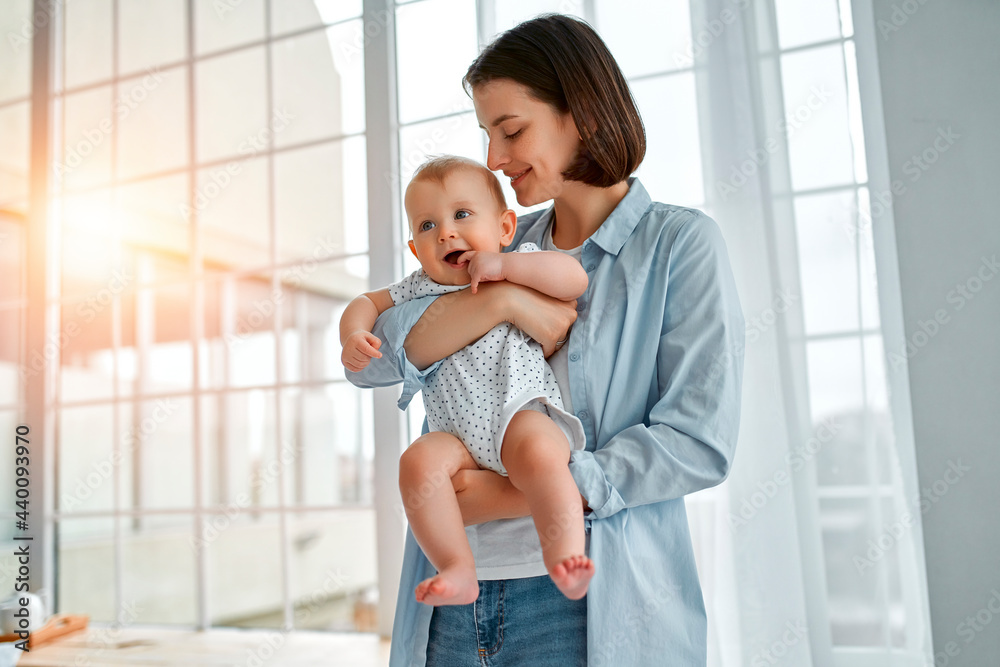 Loving mom carying of her newborn baby at home.Mom and baby boy playing ...