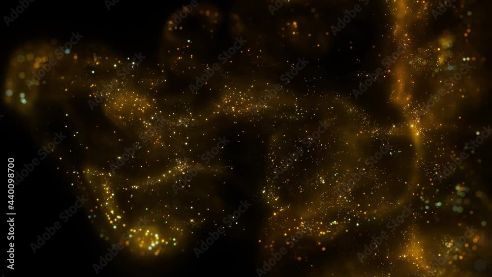 Gold dust particles fly in slow motion in the air lingering slowly ...