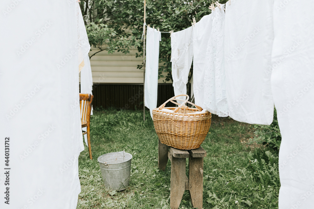 washing clothes in a basin and drying sheets and clothes on the street ...