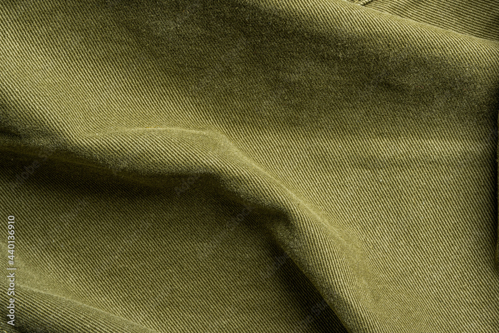 Deep moss green denim fabric with wavy texture and worn feel for design ...